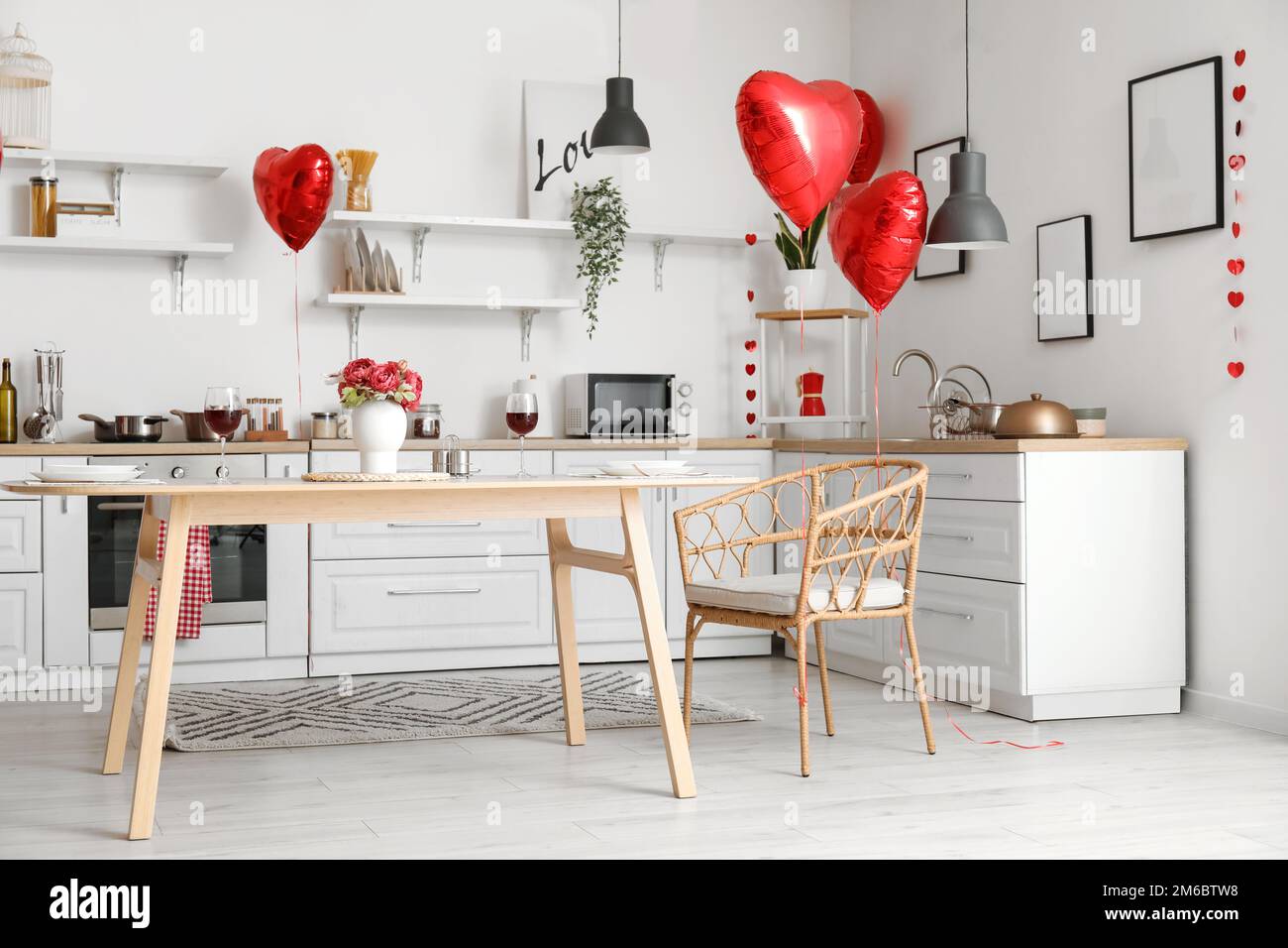 Interior of kitchen with counters, dining table and balloons for ...