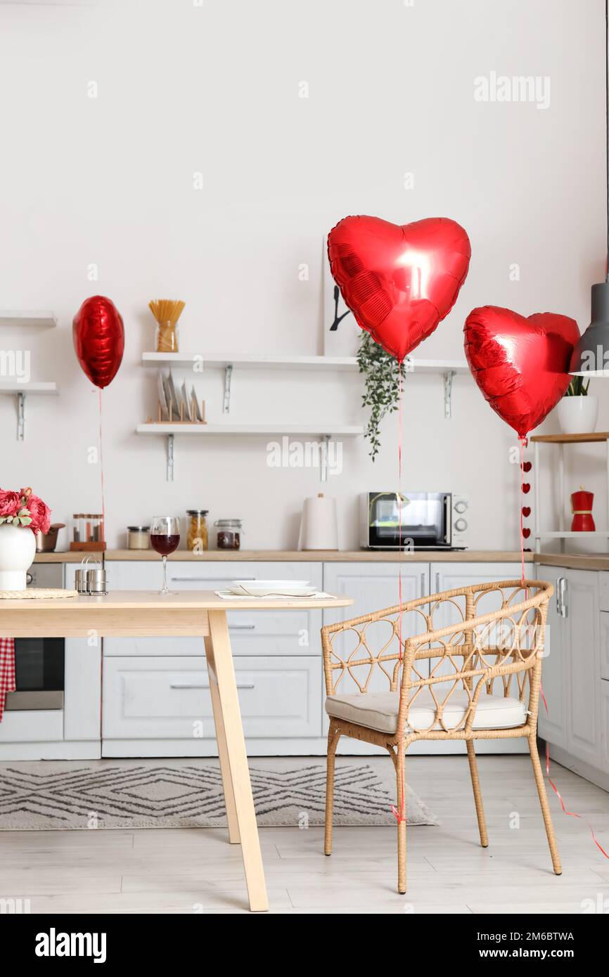 Interior of kitchen with counters, dining table and balloons for ...