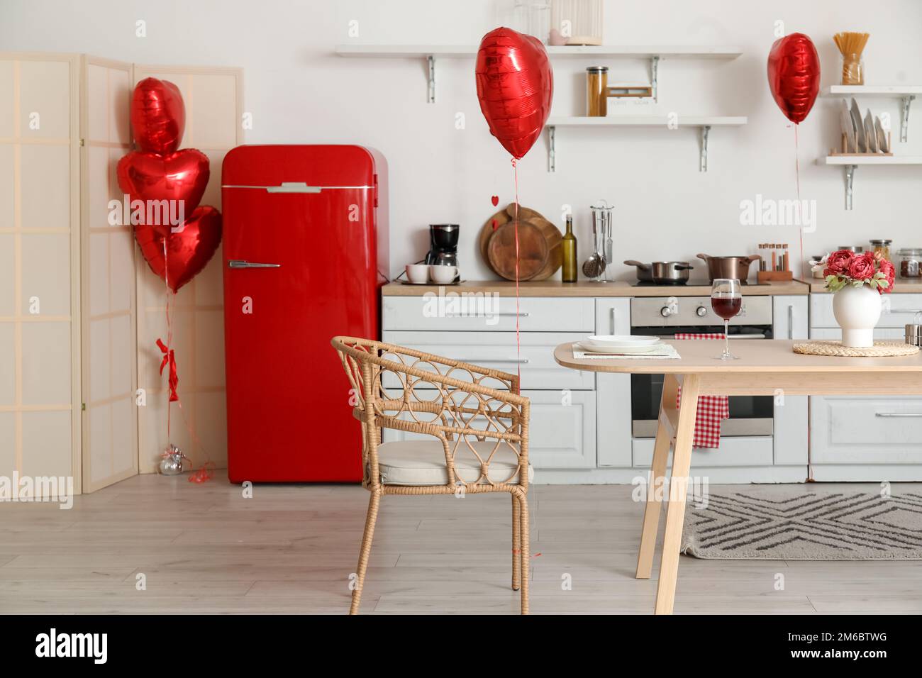 Interior of kitchen with counters, dining table and balloons for ...