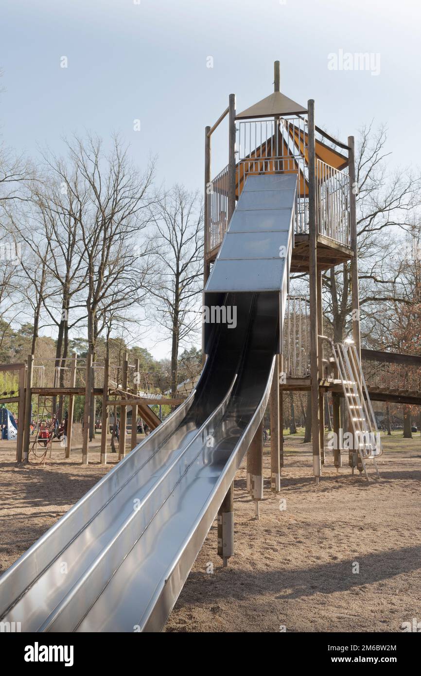 High slide for riding in the park Stock Photo - Alamy