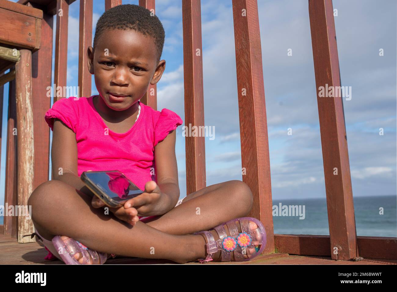 Little girl on deck with mobile phone Stock Photo - Alamy
