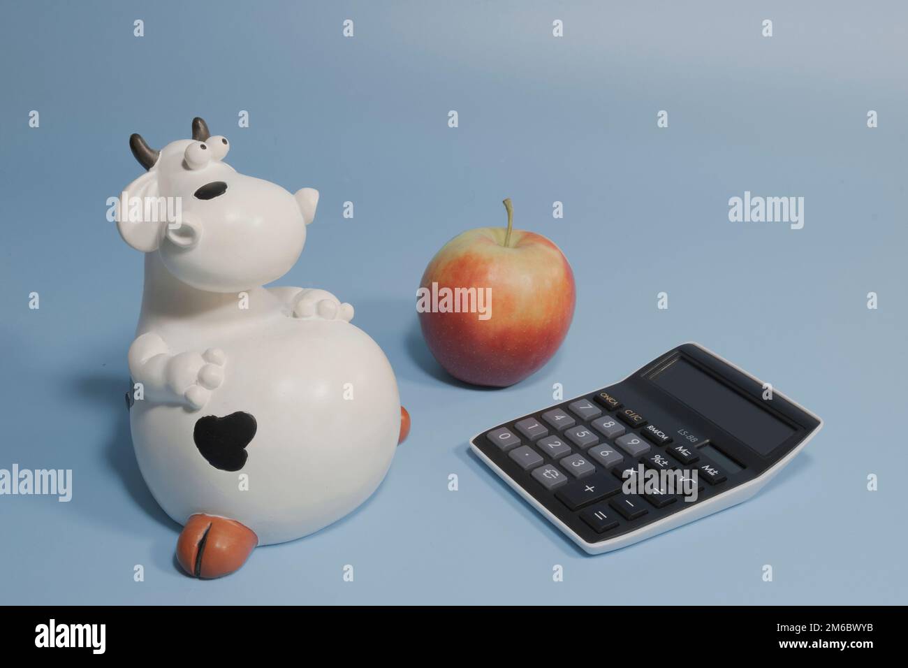 Cow apple and calculator - funny composition Stock Photo - Alamy