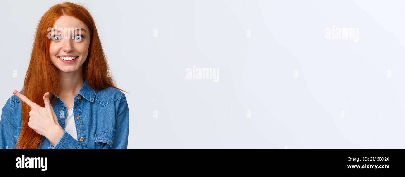 Excited and impressed, curious thrilled smiling redhead girl with long ...