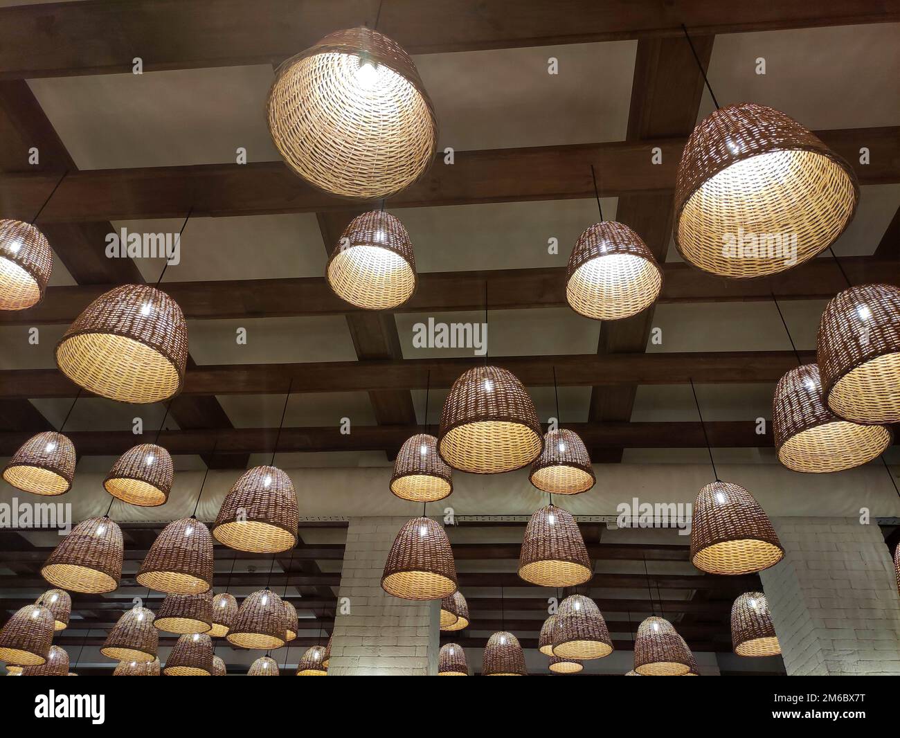 Electric lamps background. Many lamps in baskets hanging on a wooden ...