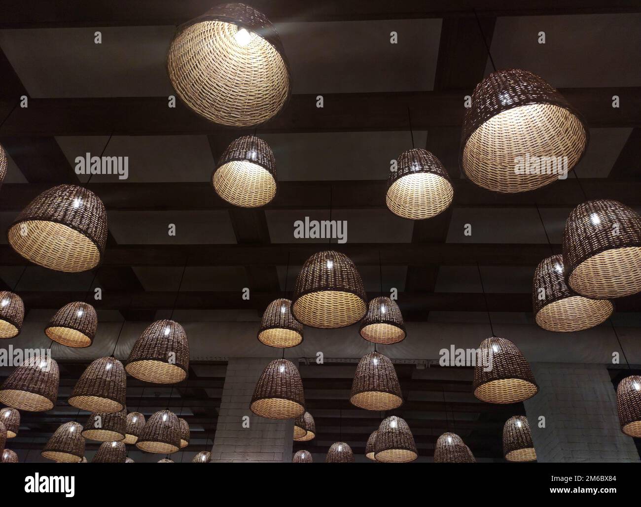 Electric lamps background. Many lamps in baskets hanging on a wooden ...