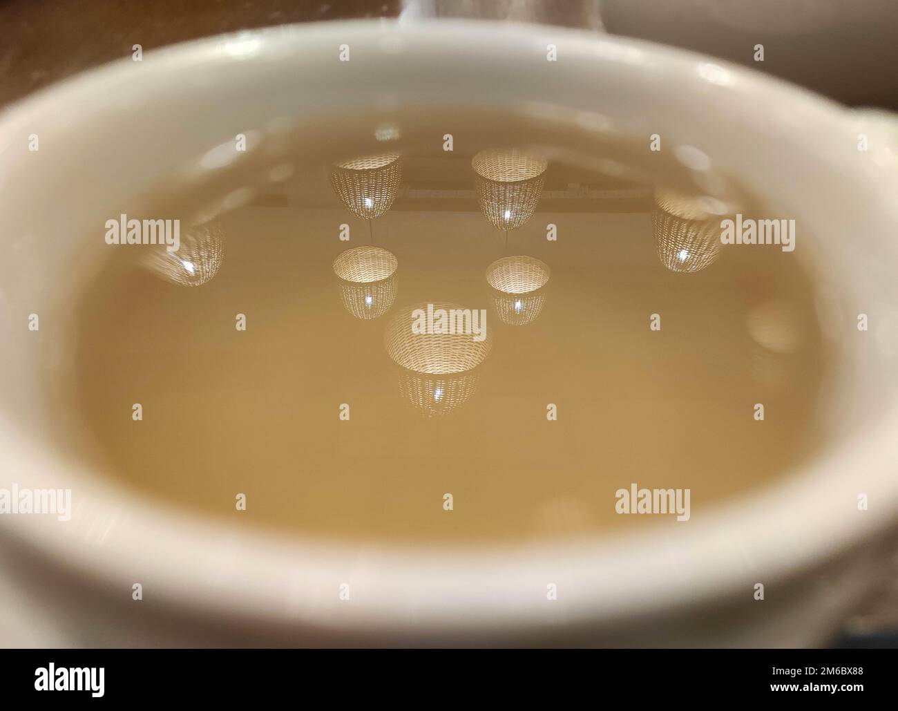Lights reflection in a cup of tea background, abstract wallpaper Stock ...