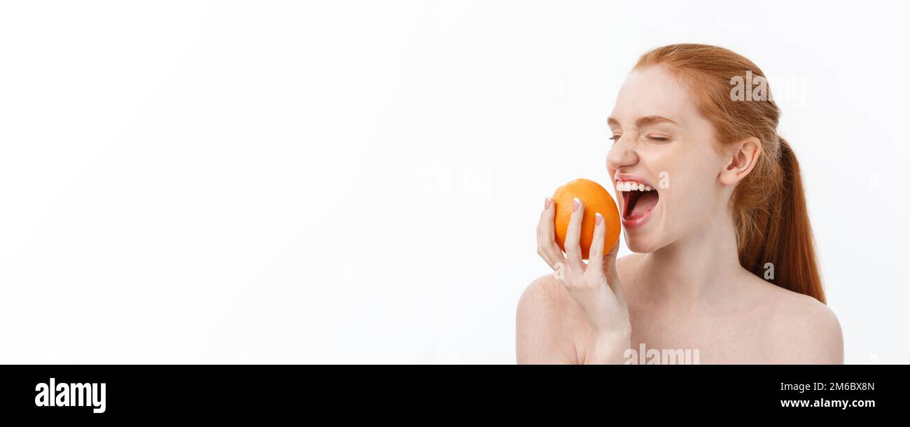 Portrait beautiful woman with a orange isolated Stock Photo - Alamy