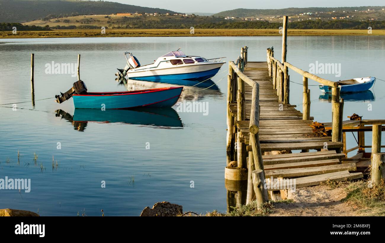 Boats on the river by jetty Stock Photo - Alamy