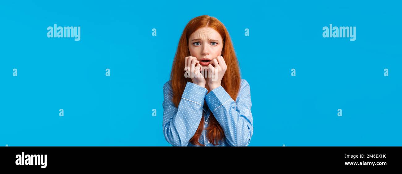 Scared and panicking young worried redhead teenage girl having ...
