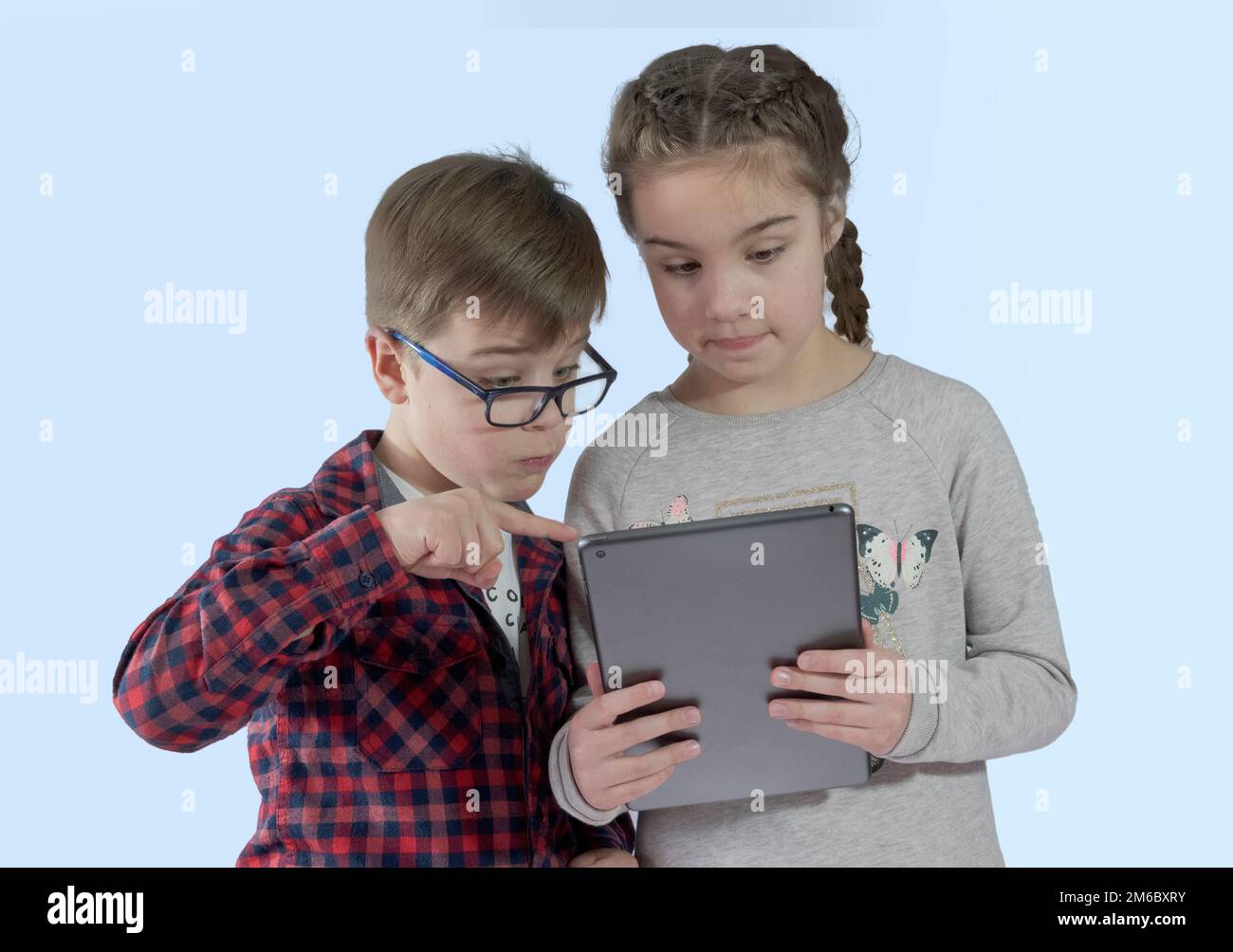 Boy and girl playing or study with tablet Stock Photo - Alamy