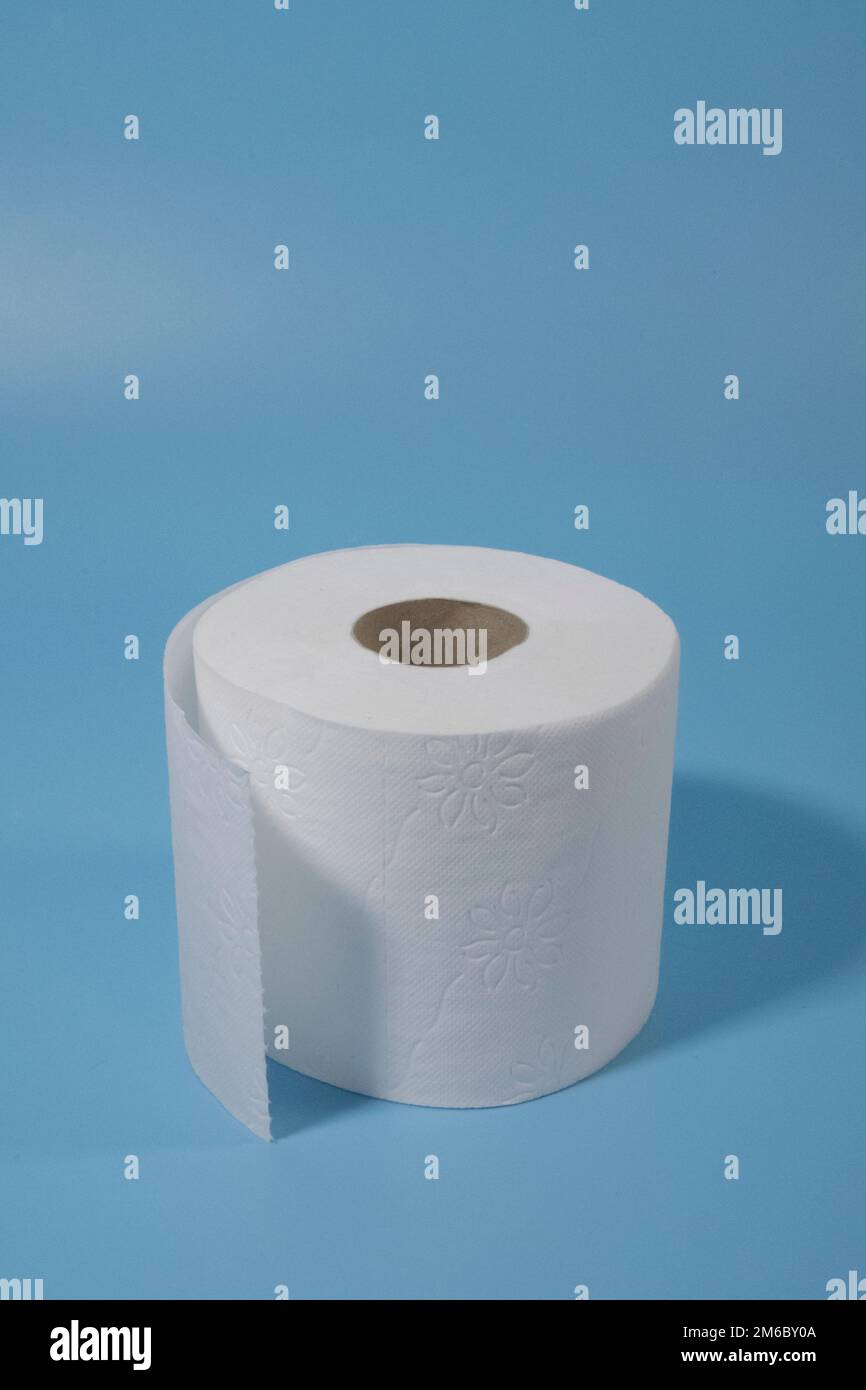 Toilet paper. one roll on blue Stock Photo - Alamy