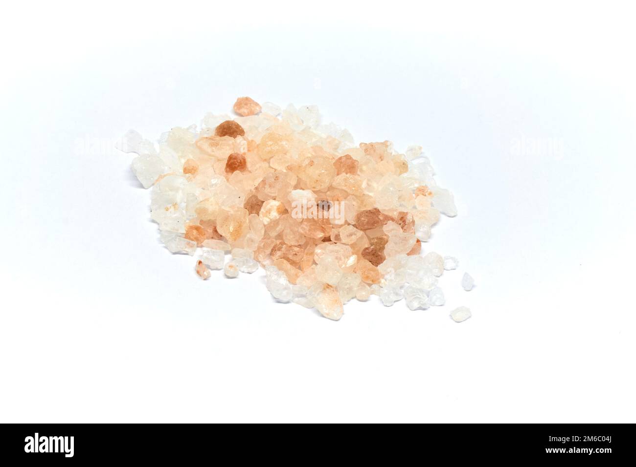 Himalayan salt pile on white background Stock Photo - Alamy
