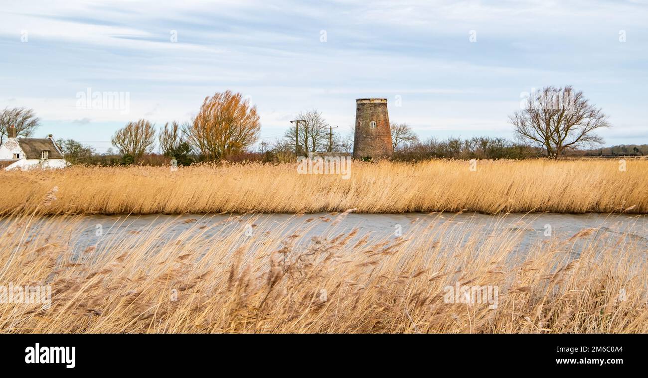 Abandoned drainage mill and house on the bank of the River Bure in ...