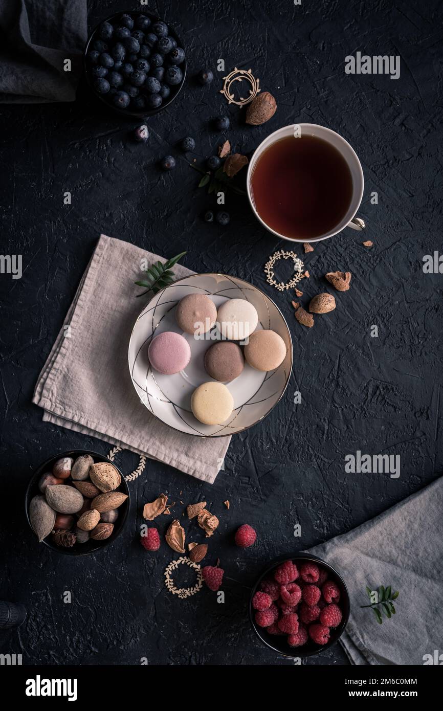 dark mood food with macaroons in a plate. the macaroon is a small ...