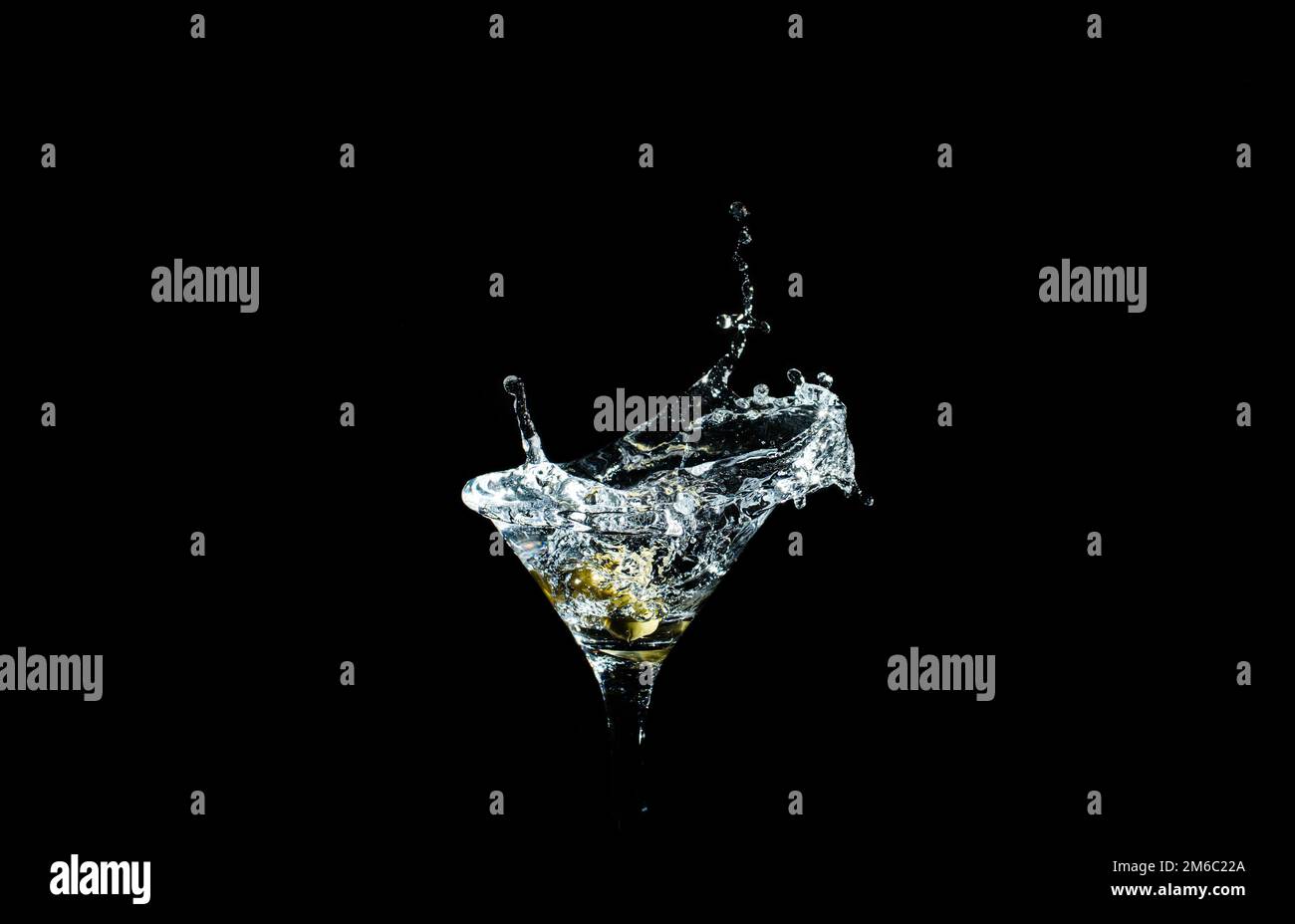 Olive splashing on cocktail isolated on black background Stock Photo ...