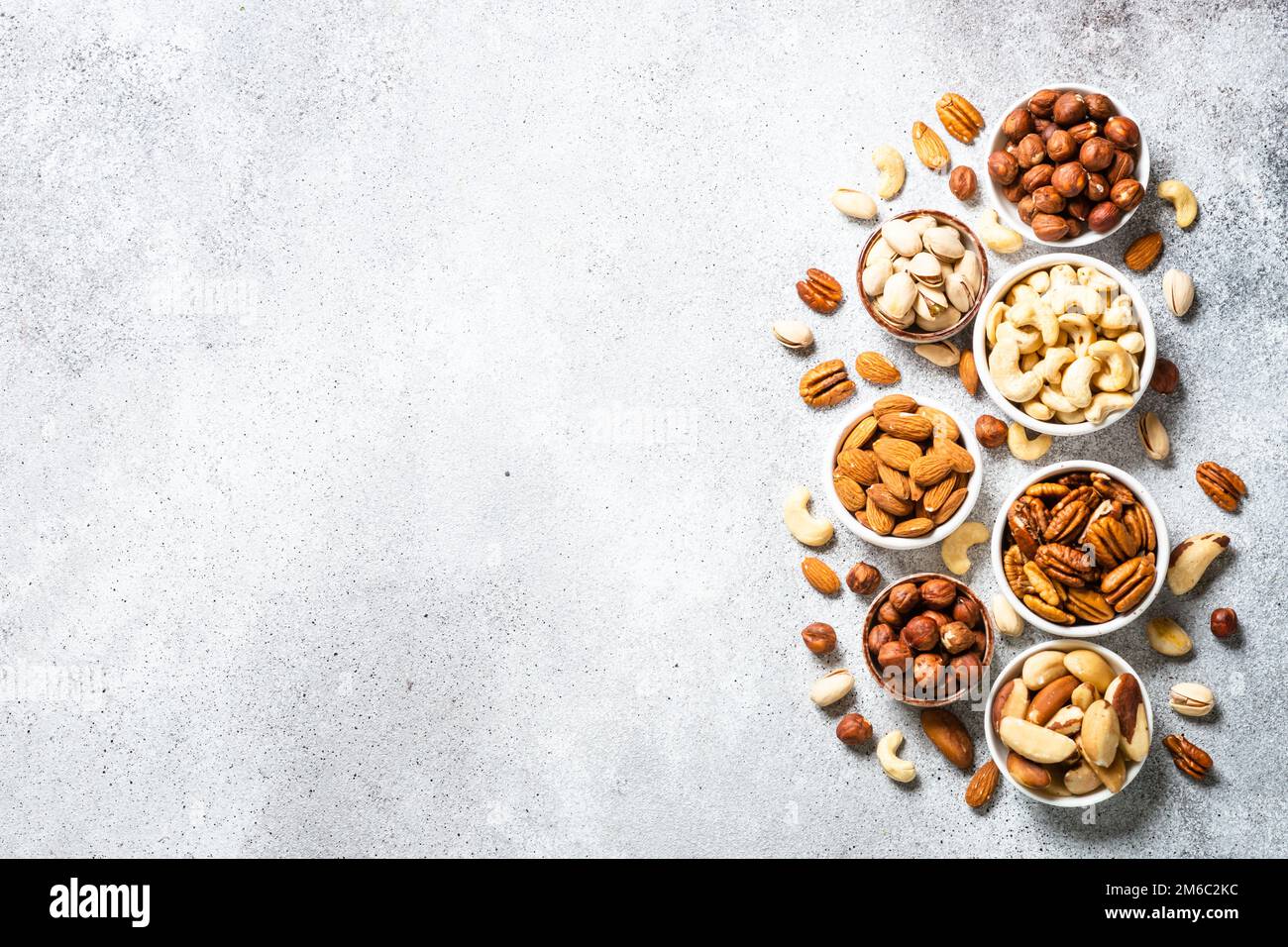 Assortment of nuts in bowls. Cashew, hazelnuts, pecan, almonds ...