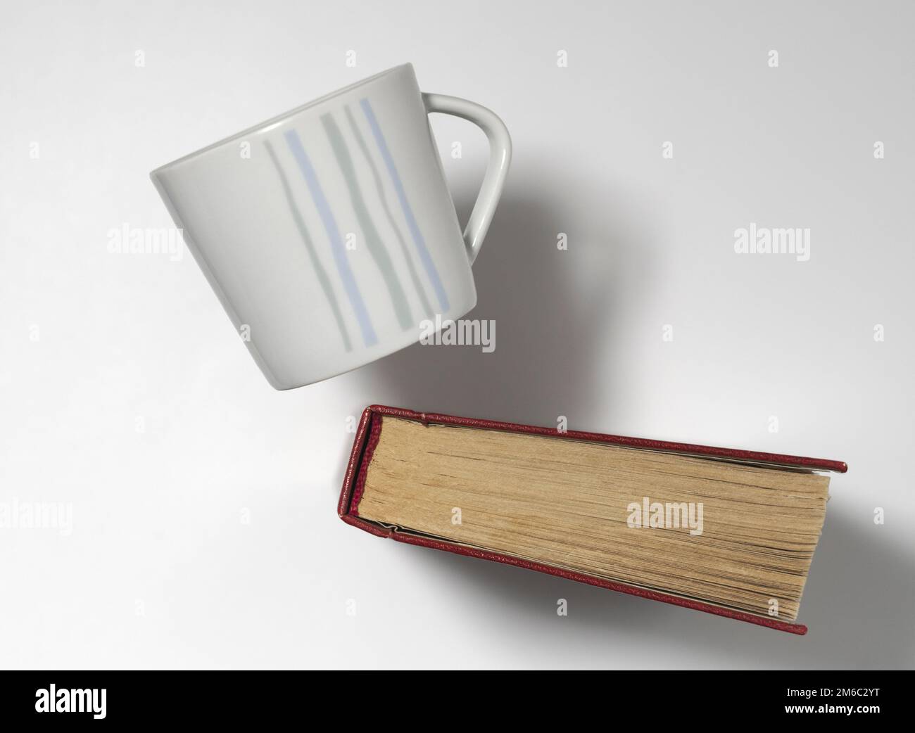 Cup and book, abstraction, levitation in space on a white background ...