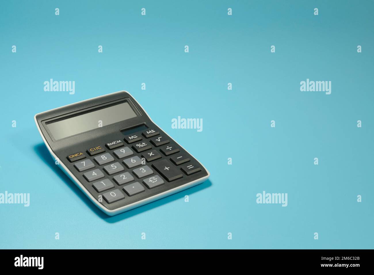 Desktop calculator. on a blue background. blank screen Stock Photo - Alamy