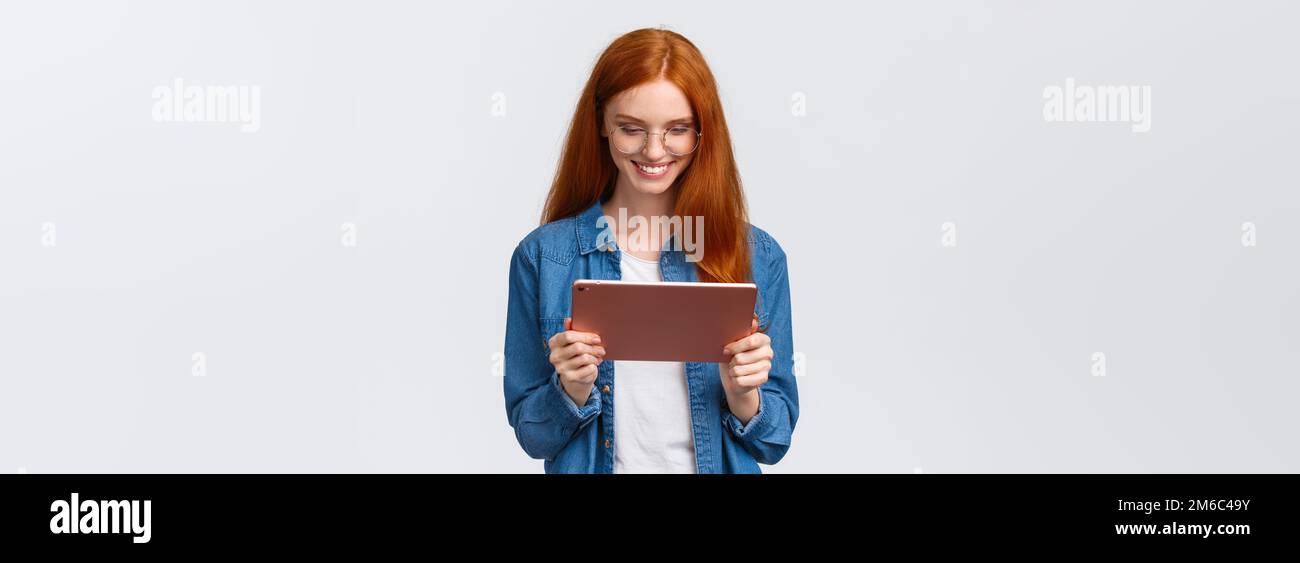 Waist-up portrait pretty happy redhead female student, studying ...