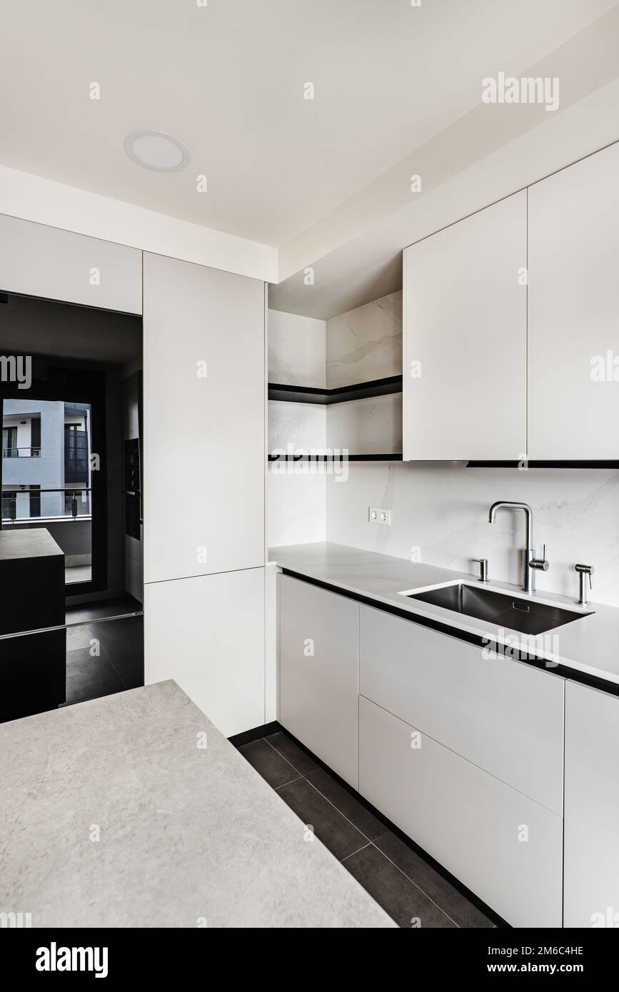modern designed kitchen with smooth handleless cabinets with black ...