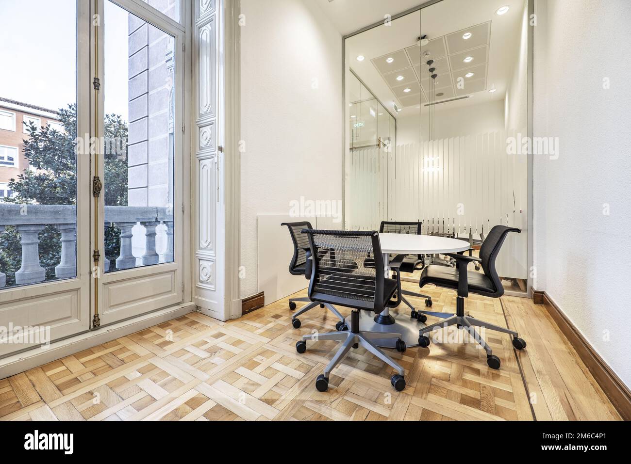 Vintage style building office with round meeting table, glass ...