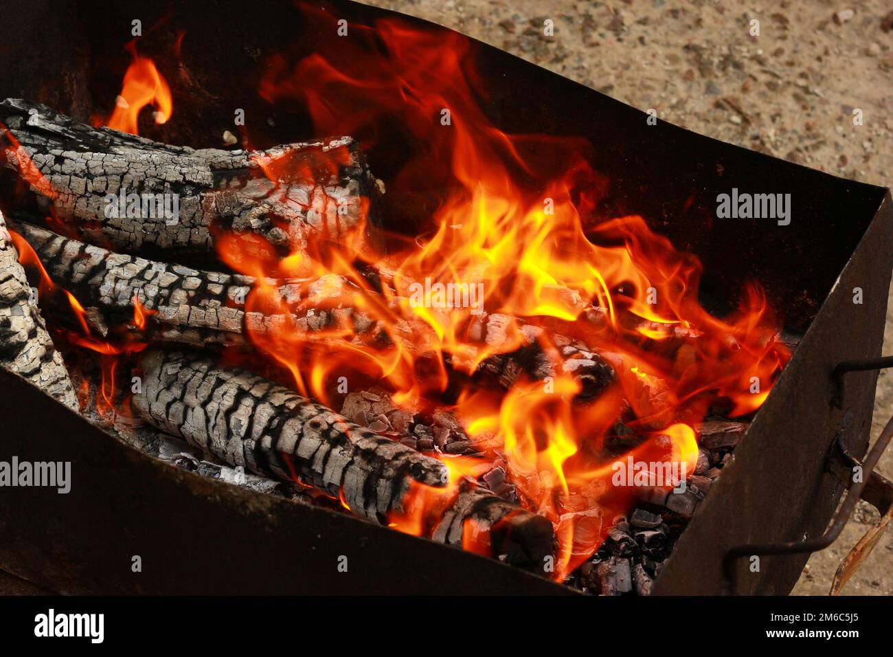 Burning fire and grill outdoor Stock Photo - Alamy