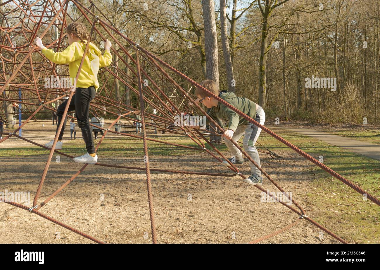 Boy and girl on a сhildren's attraction-cobweb Stock Photo - Alamy