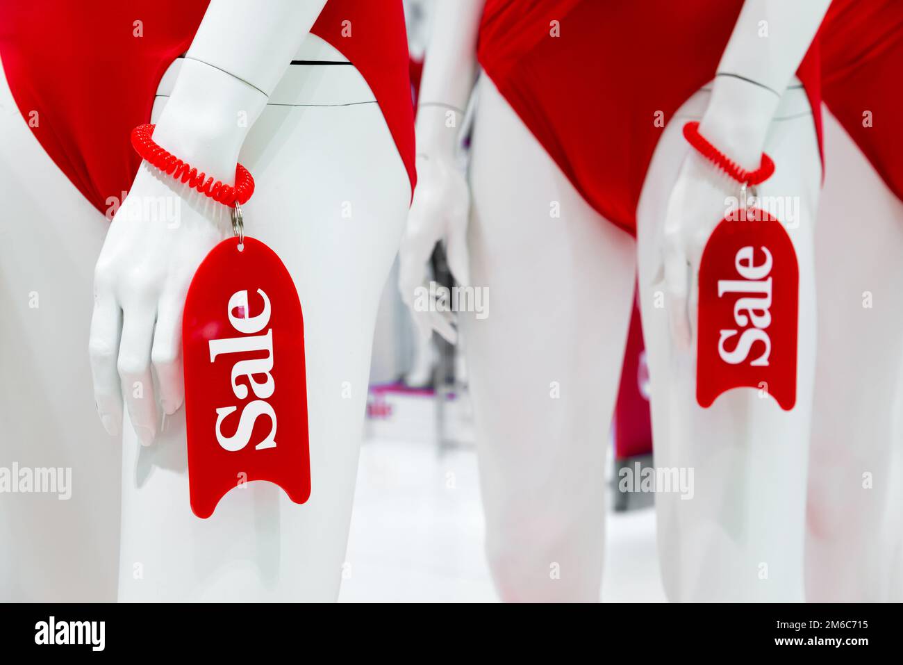 Sale - the inscription on plate on the arm of the dummy in the store ...