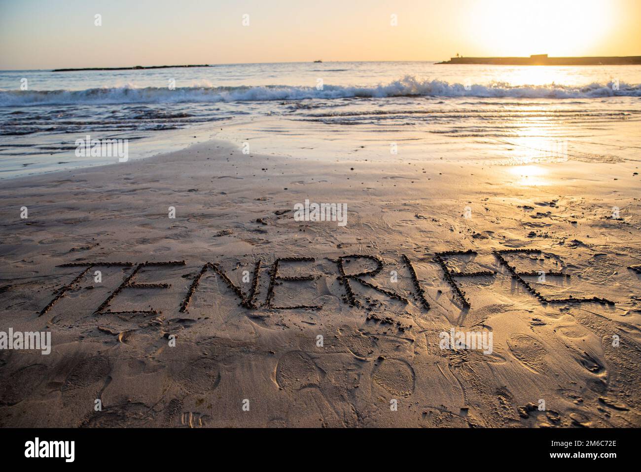 "Tenerife" written on the sand at the beach during sunset, photo with ...