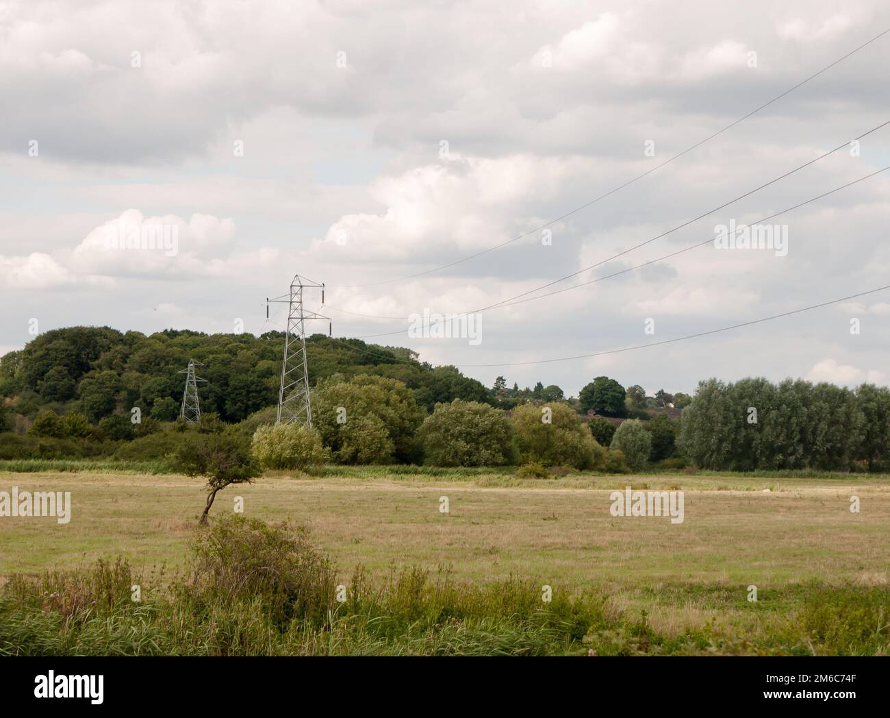 A metal pylon outside in the country with wires overhead Stock Photo ...