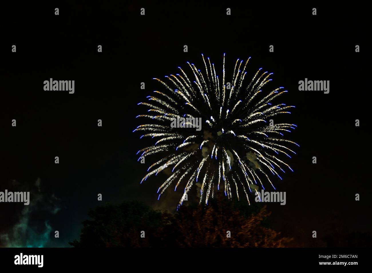 On the night sky, a bright firework ball flashed Stock Photo - Alamy