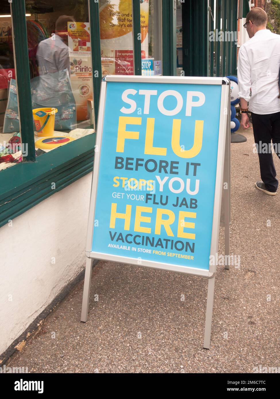 Sign outside pharmacy stop flu before it stops you Stock Photo - Alamy