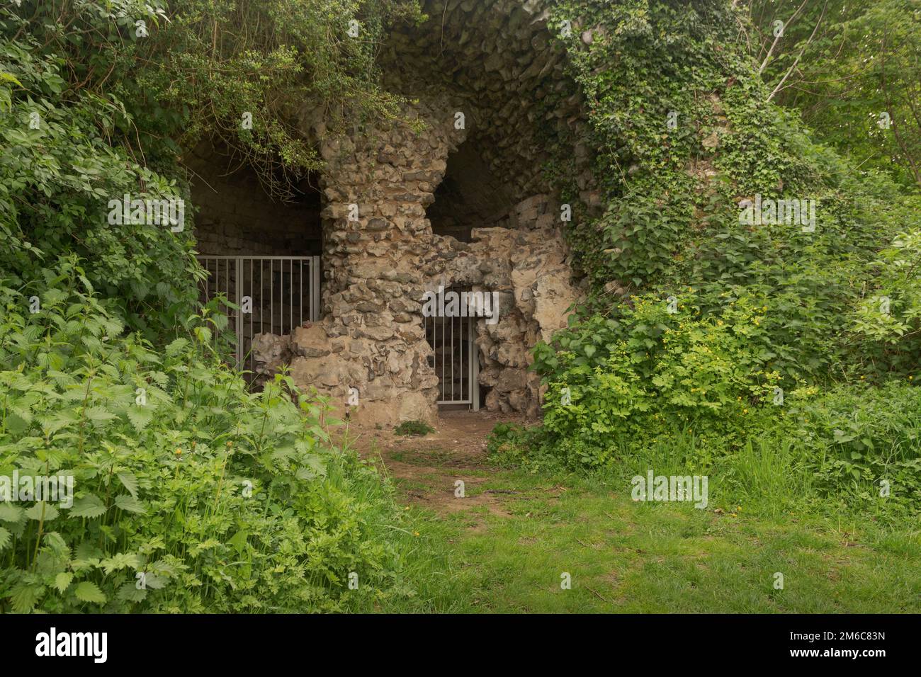 Entrance to the ancient grotto near the medieval castle Stock Photo - Alamy