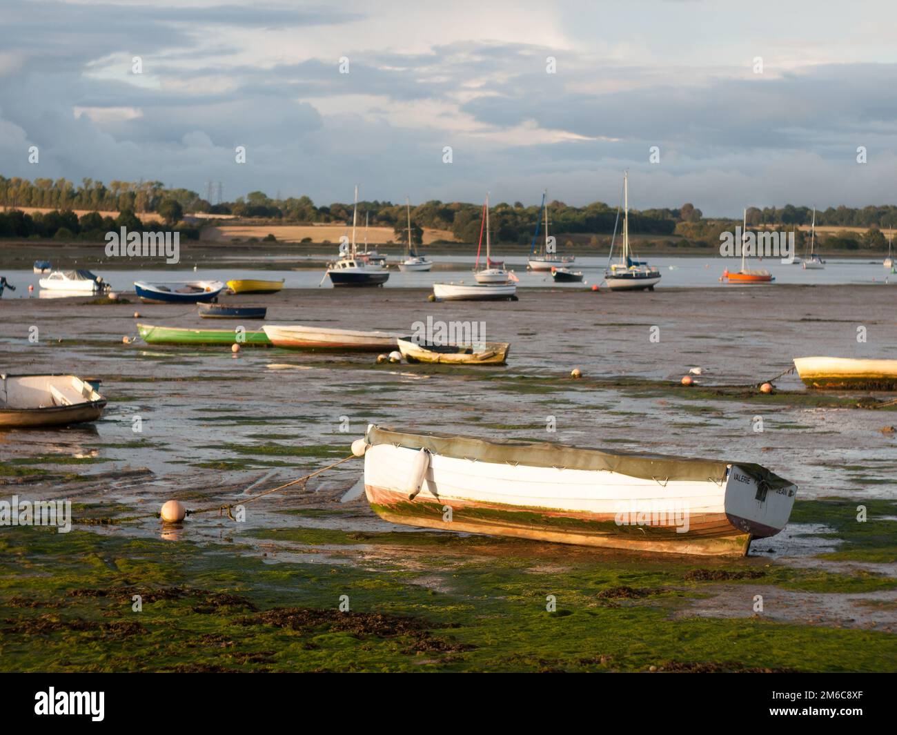 Estuary scene in manningtree with moored boats tide clouds landscape ...