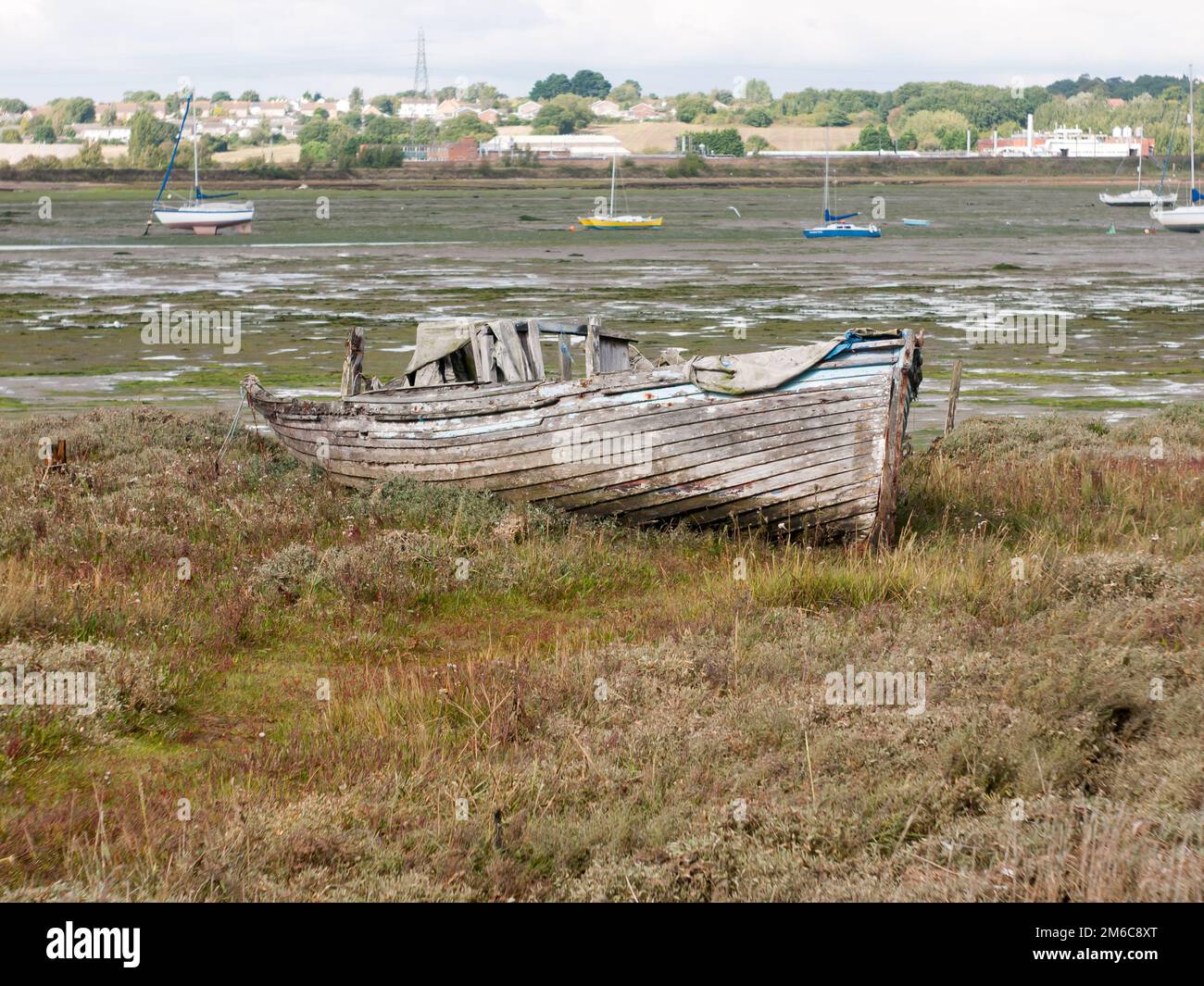 Old wooden boat ruins decaying abandoned estuary scene Stock Photo - Alamy
