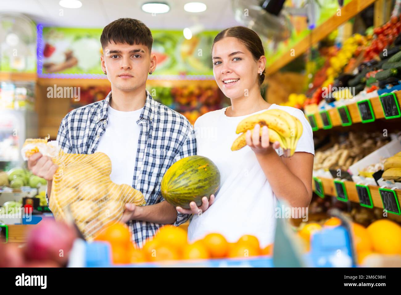 Couple choosing fresh foods in fruit and vegetable section of ...