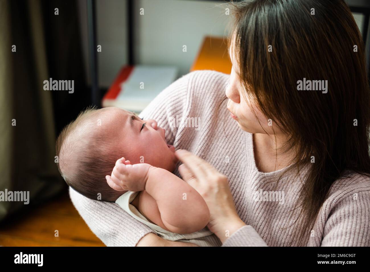 Parent woman cuddling baby tenderness Stock Photo - Alamy