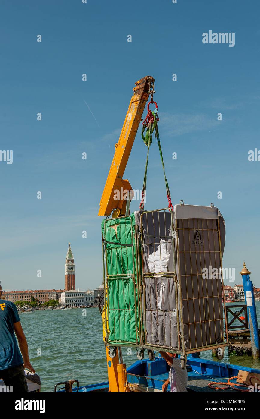 Venice Italy August 21 2017 : Crane unloading metal baskets with hotel ...