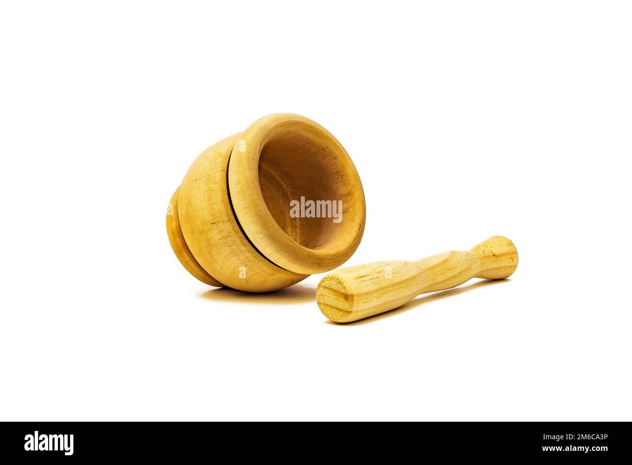 Wooden mortar for shredding various culinary ingredients on a white ...