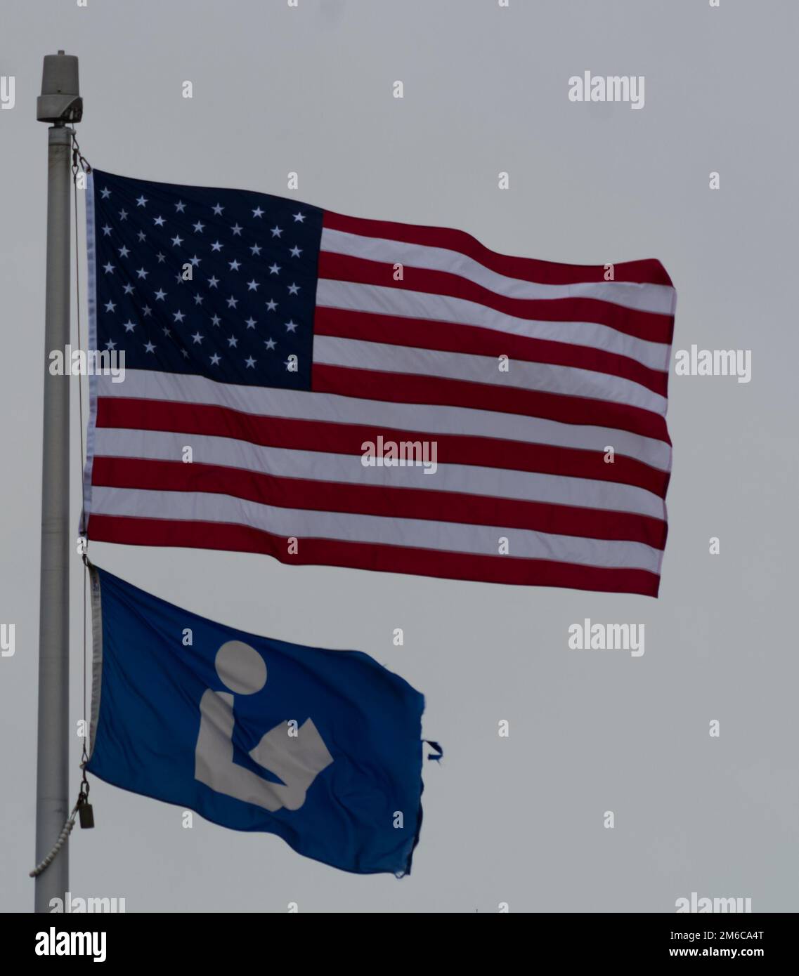 A vertical shot of the United States lag and a library flagon a pole ...