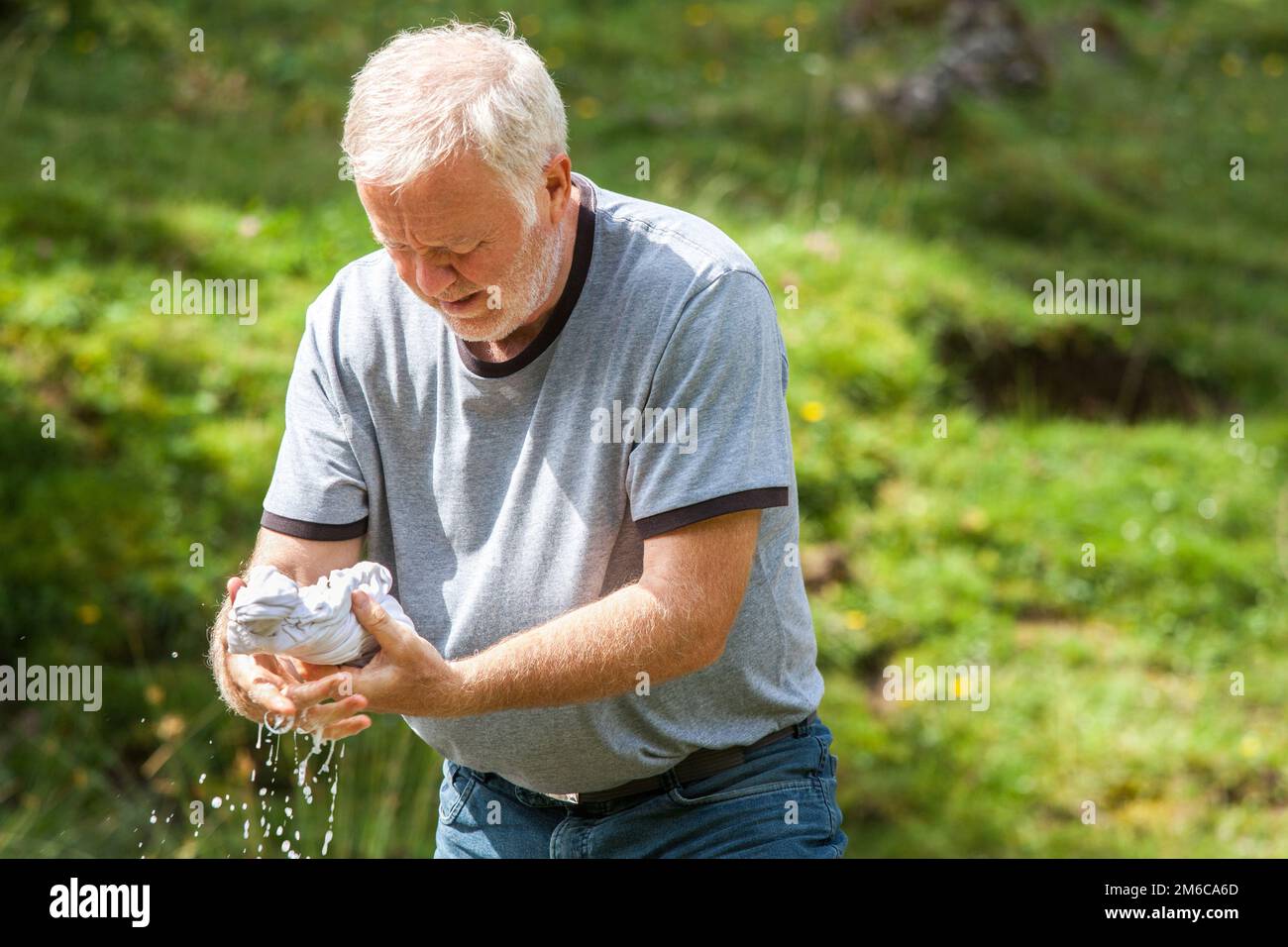 Man doing his own laundry in nature Stock Photo - Alamy