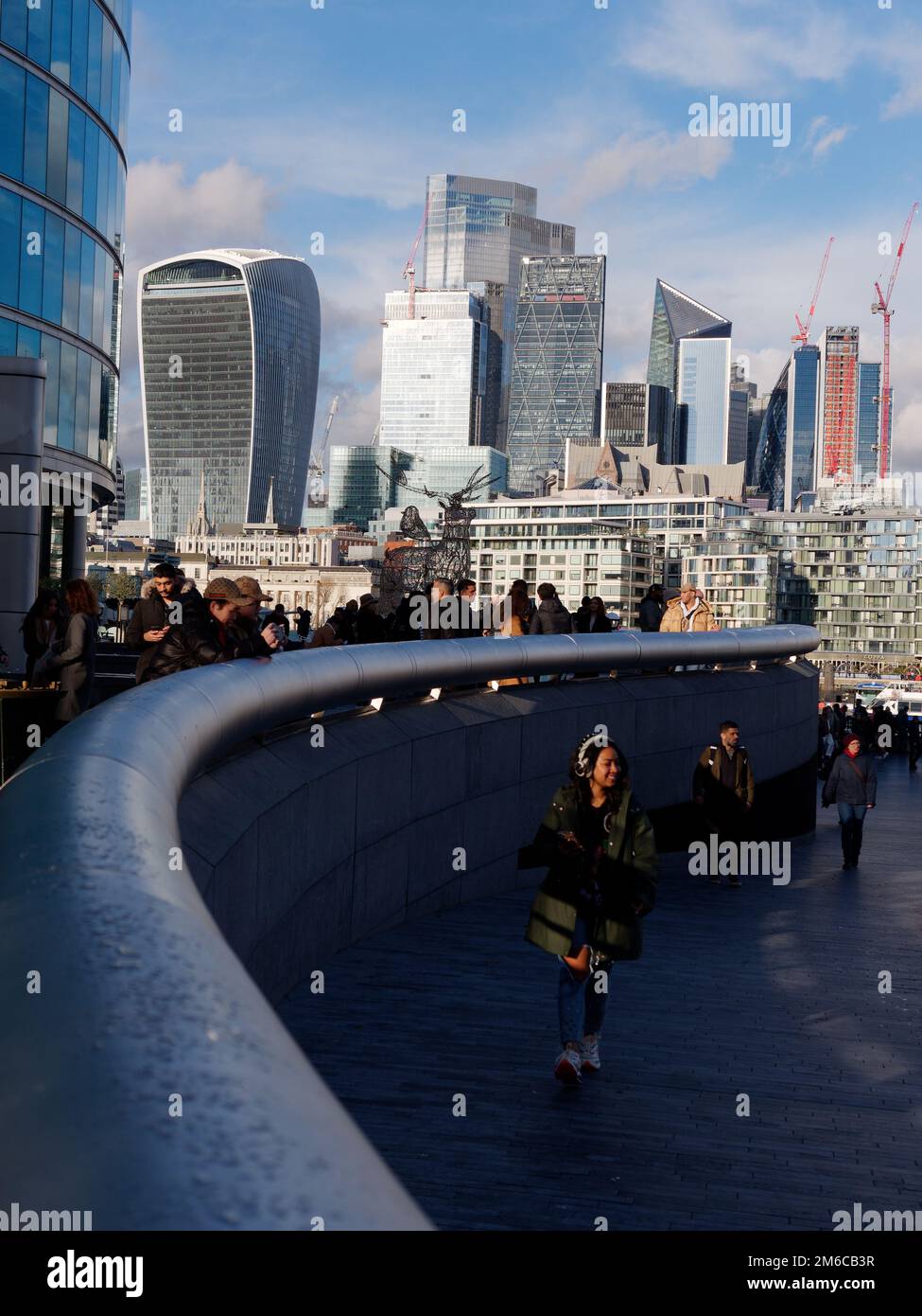 People walking in the South Bank area with skyscrapers behind including ...