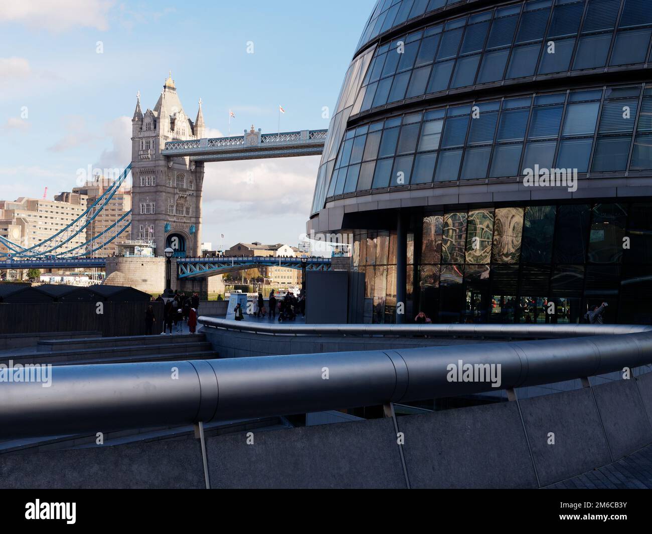 City Hall and Tower bridge with a rail in the forground providing a ...