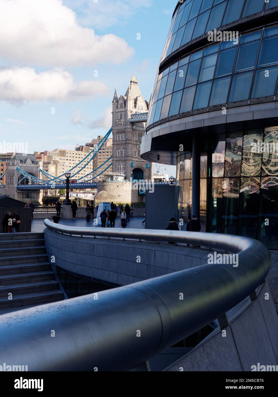 City Hall and Tower bridge with a rail in the foreground providing a ...