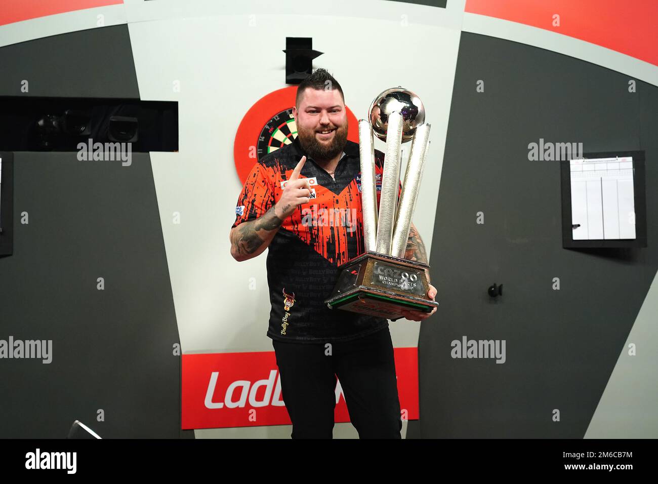 Michael Smith celebrates with the Sid Waddell trophy after winning the ...