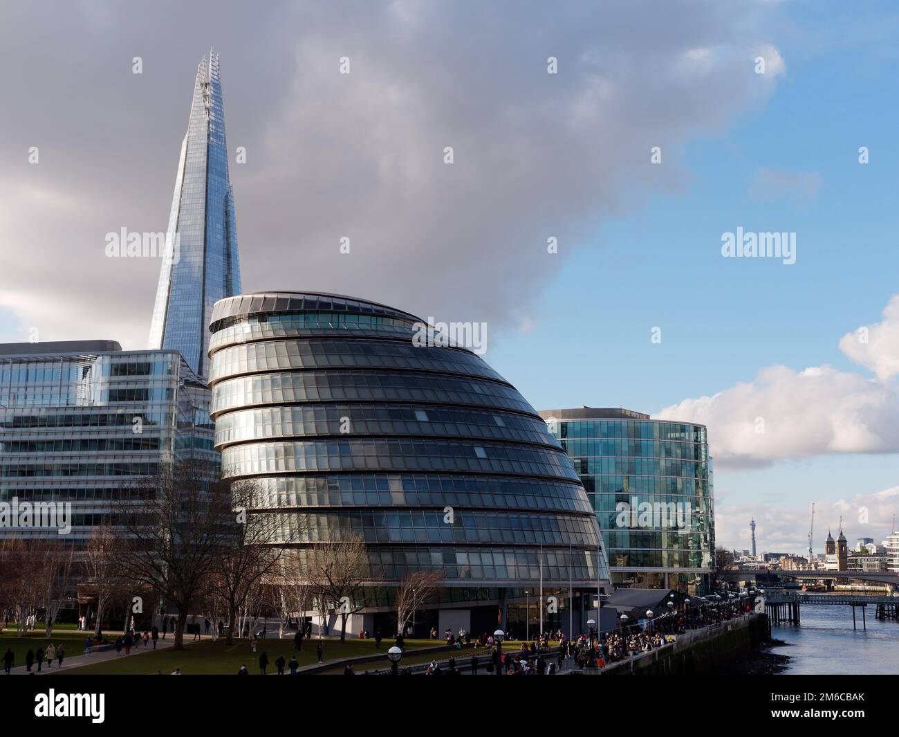 City Hall with The Shard Skyscraper behind. People line the south bank ...