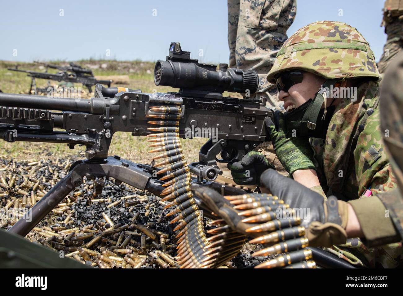Japan Ground Self-Defense Force members fire an M240B machine gun ...