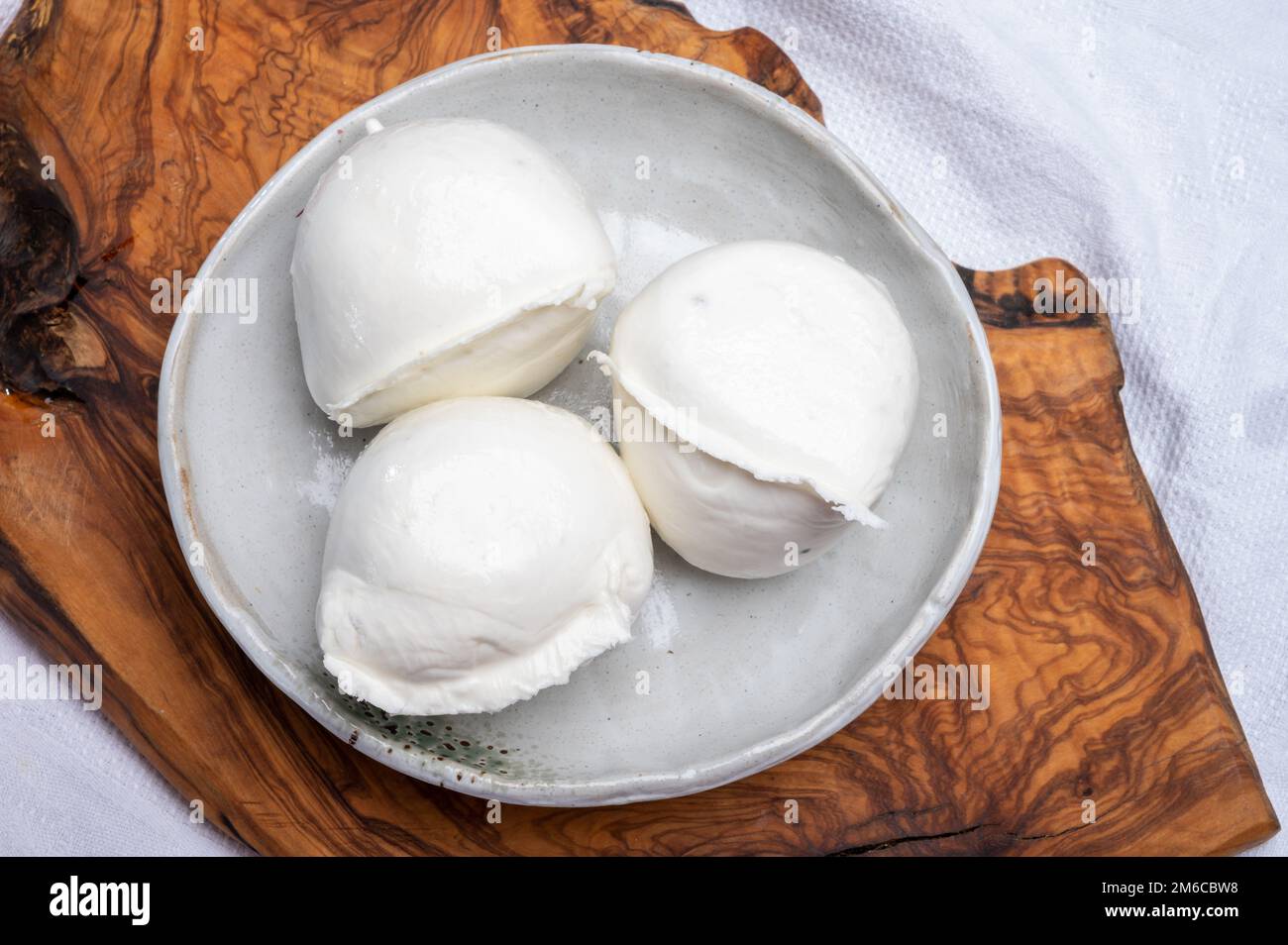 White ball of Italian soft cheese Mozzarella di Bufala Campana close up ...