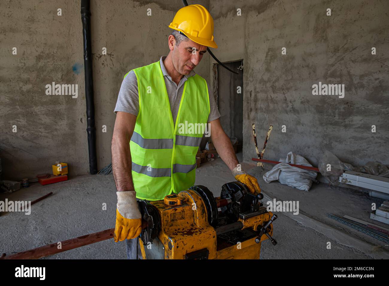 Technician is grooving steel pipe. Iron pipe master working iron pipes ...