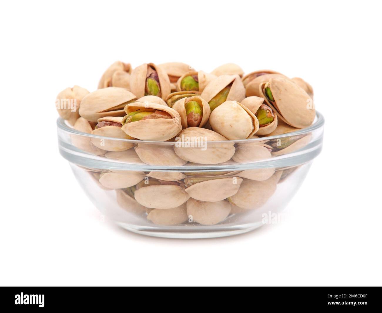 Salted pistachios in a glass bowl isolated on white Stock Photo - Alamy